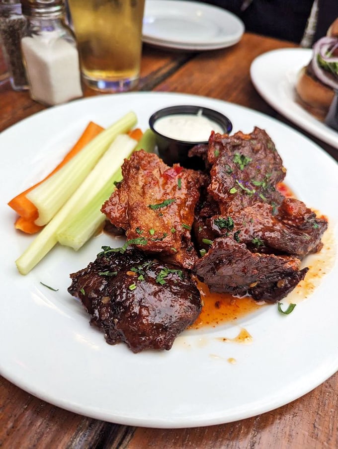 These wings aren't just cooked—they're transformed. Glistening with sauce and served with the crisp vegetables you'll probably ignore.