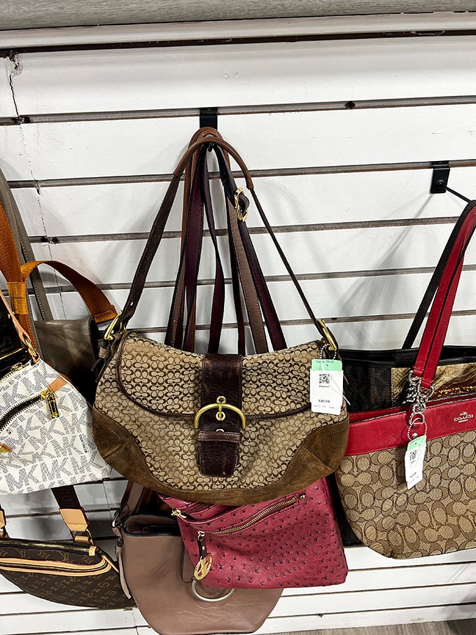 Designer handbags hang like ripe fruit, waiting to be plucked by savvy shoppers who know authentic Coach doesn't require a coach's salary.