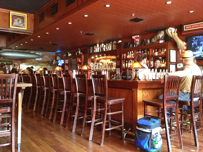 The bar's warm glow invites you to pull up a stool and stay awhile—because burger pilgrimages deserve proper hydration. 