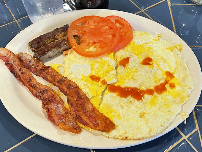 Eggs, bacon, and hot sauce—the holy trinity of breakfast, presented without apology or unnecessary garnish. Just as it should be.