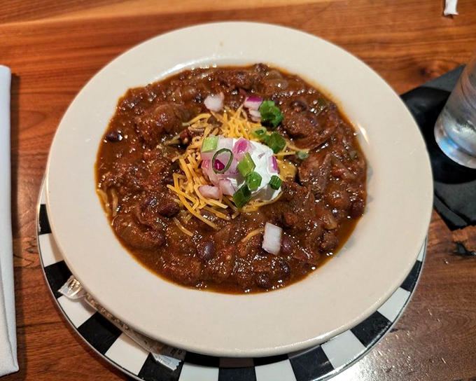 This isn't your camping trip chili – it's a rich, complex stew topped with cheese, onions, and a dollop of sour cream.