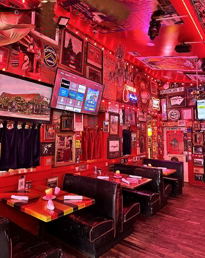 The dining room glows with that signature red light, making everyone look like they're having the time of their lives – because they probably are.