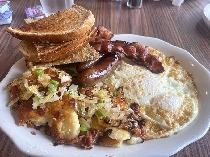 The breakfast plate that launched a thousand productive days—eggs, bacon, hash browns, and toast in perfect harmony.