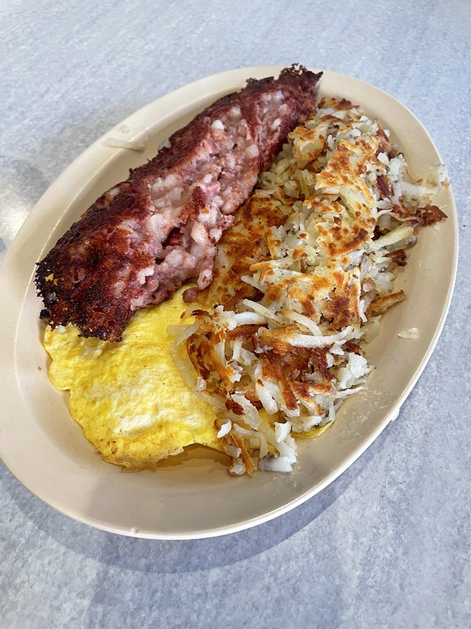 The holy trinity of breakfast: crispy bacon, golden hash browns, and eggs so sunny they should come with SPF 30.