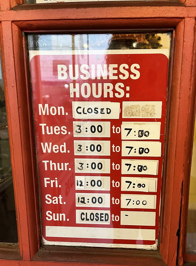 Hours posted with handwritten precision—a sign of a place that does things the old-school way, including their transcendent chicken recipe.