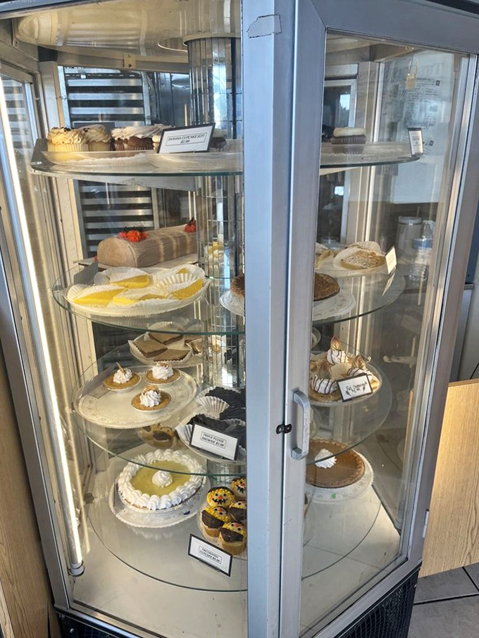 The rotating cake display showcases everything from classic pies to celebration cakes, each one made with the same care as their famous donuts.