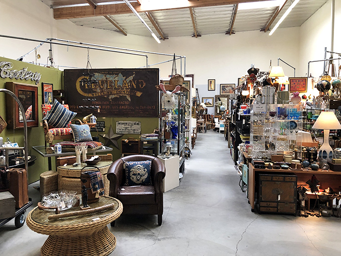 That leather club chair isn't just seating—it's a front-row ticket to the past, surrounded by enough vintage signage to open your own time capsule.