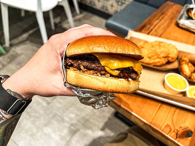 This isn't just a cheeseburger—it's a work of art. The melted cheese cascading over those crispy edges is what burger dreams are made of.