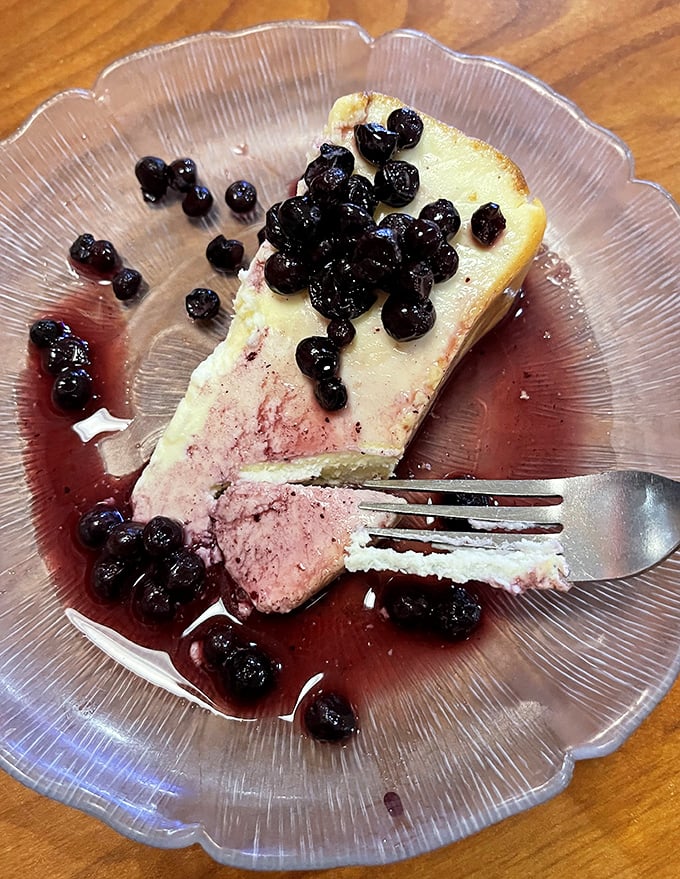 This cheesecake with blueberry compote isn't just dessert—it's edible artwork that makes you wonder why you ever considered sharing.