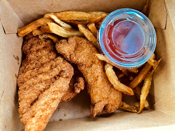 Comfort food in its natural habitat—golden-fried chicken tenders and fries in an unpretentious box, ready to soothe whatever ails you.