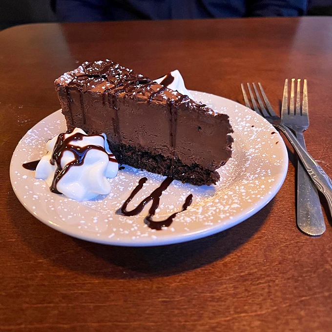 A chocolate cake so rich it should come with its own tax bracket, balanced by that perfect dollop of whipped cream.