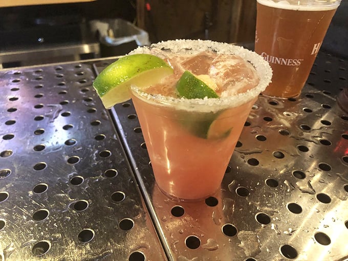 A cocktail with a salt rim that's dressed better than most people at formal events. The lime wedges aren't just garnish—they're essential supporting actors.