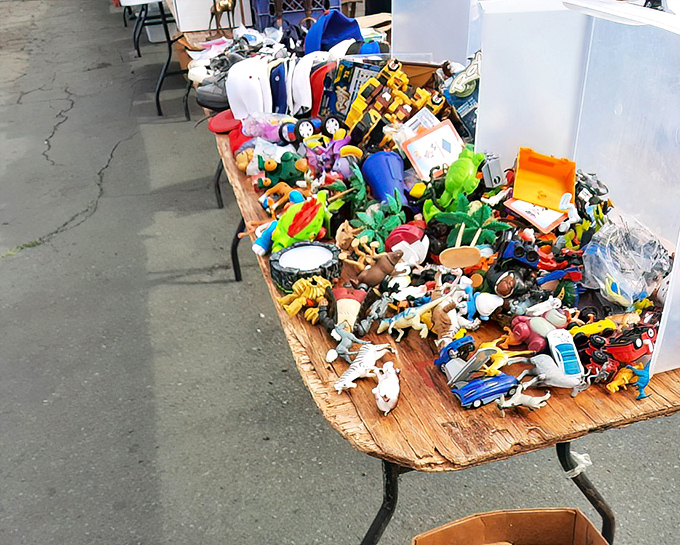 A colorful chaos of childhood memories for sale—where one person's toy box cleanout becomes another's nostalgic treasure.