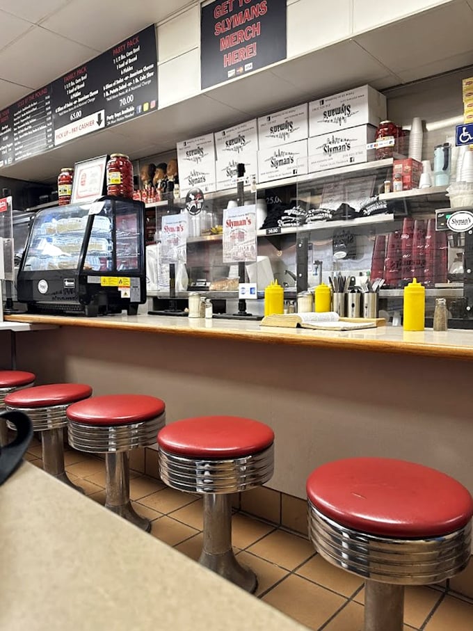 Classic diner counter seating with those perfect red stools – the front-row seats to the sandwich-making spectacle.