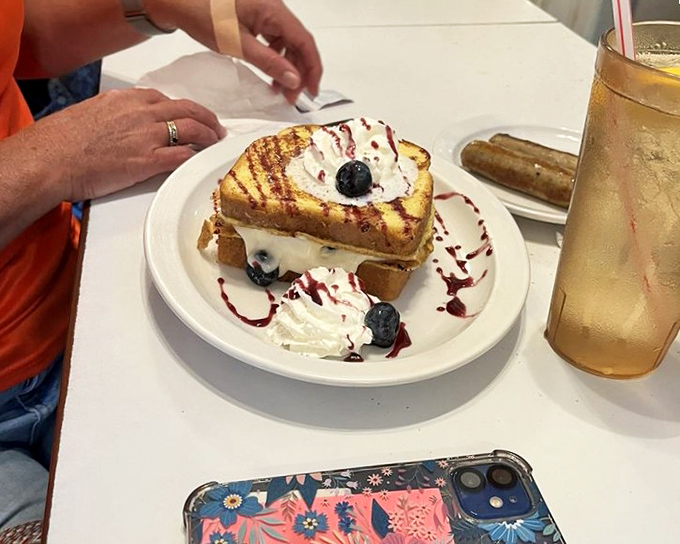 French toast elevated to art form status. Those blueberries and cream aren't just toppings—they're a statement that breakfast can also be dessert. And that's fine.