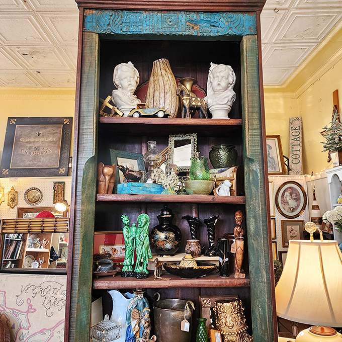This antique cabinet doesn't just display collectibles—it showcases the artistry of a bygone era when craftsmanship meant something and turquoise was always in style.