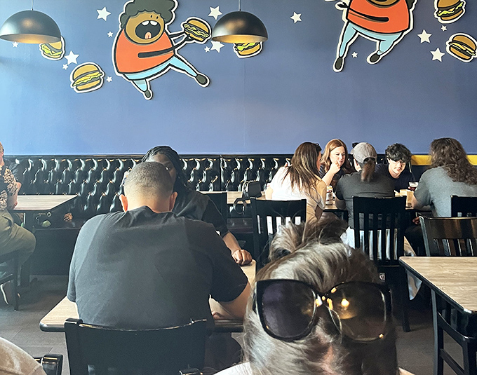 The dining room buzzes with the universal language of burger appreciation—notice how nobody's talking? That's the sound of culinary bliss.