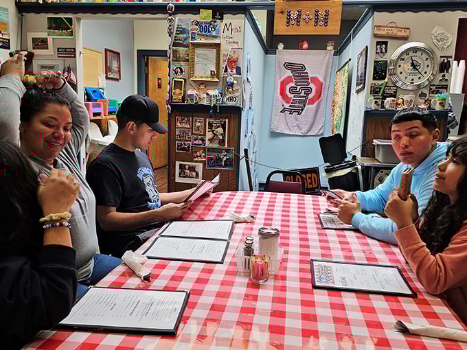 Red checkered tablecloths set the stage for family gatherings where menu deliberations are serious business and everyone has their regular order.