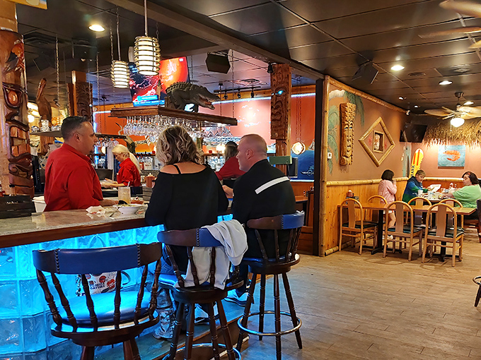 The bar area—where locals swap fishing tales and tourists pretend they know what they're talking about. The blue lighting adds underwater ambiance.