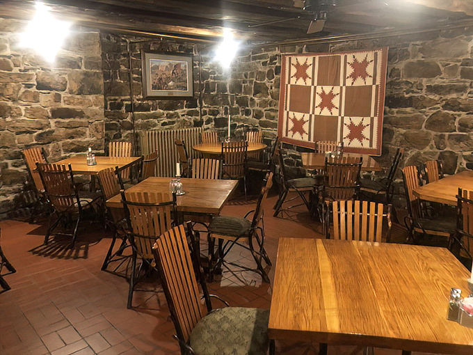 The dining room feels like colonial America's coziest corner. That quilt on the wall isn't just decoration—it's a textile time machine.