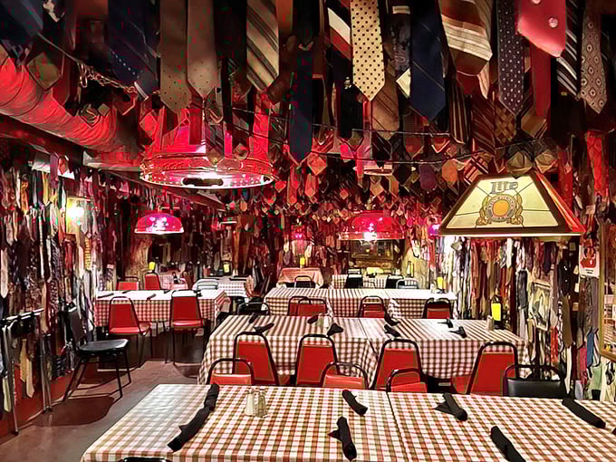 Red checkered tablecloths and dangling ties create a dining room that's equal parts roadhouse charm and sartorial rebellion.