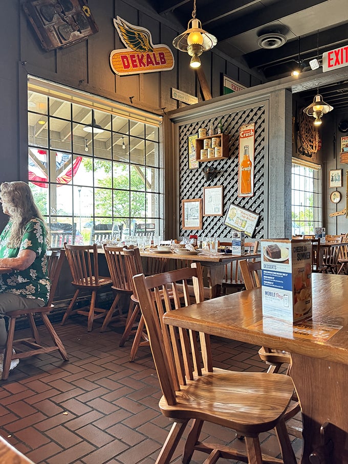 Rustic charm meets comfort in this dining area, where vintage signs and wooden accents create the perfect backdrop for serious eating business.