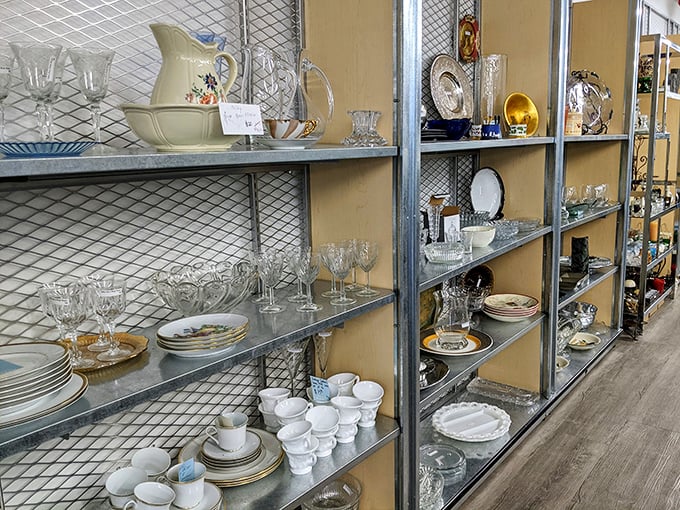 Crystal stemware and everyday dishes coexist democratically on these shelves – one person's downsizing becomes another's dining room upgrade.