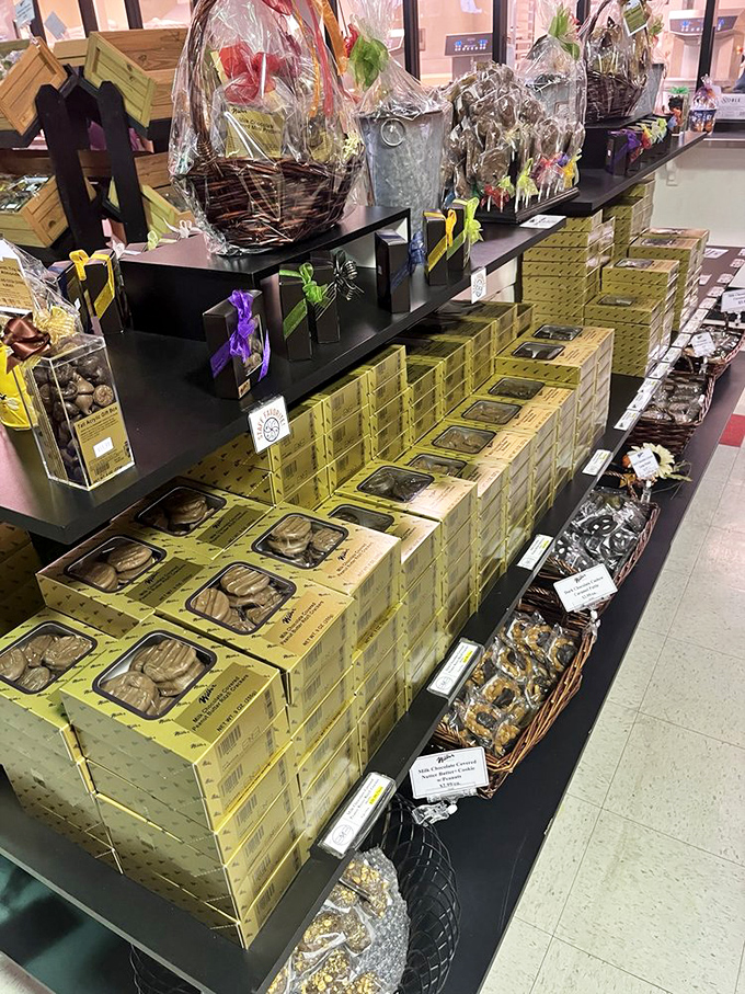 A chocolate wonderland of gift baskets and boxed treats arranged with the precision of a Broadway set designer. Willy Wonka would be taking notes.
