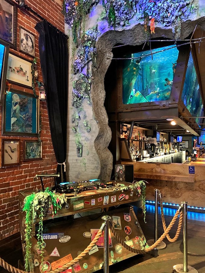 The marriage of exposed brick and underwater elements creates a space that feels both industrial and magical.