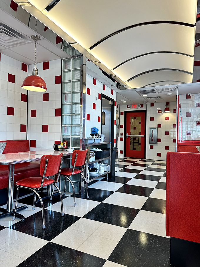 Red chairs, chrome accents, and those iconic white-and-red checkered tiles—this isn't decoration, it's a love letter to American dining.
