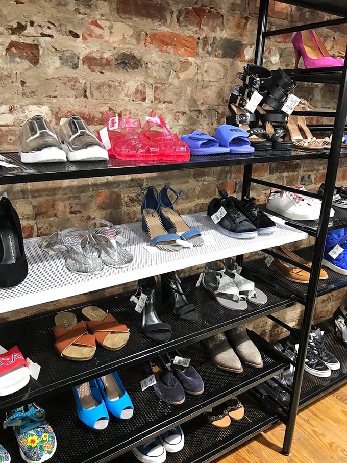 Footwear heaven against exposed brick walls—from practical flats to statement heels, each pair awaits its Cinderella moment.
