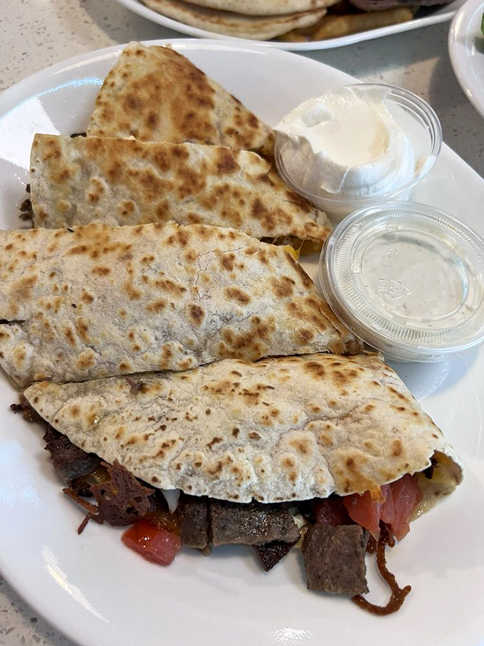 Fusion food before it was trendy—these Greek quesadillas marry Mediterranean flavors with Tex-Mex technique in a culinary peace treaty that works deliciously well.
