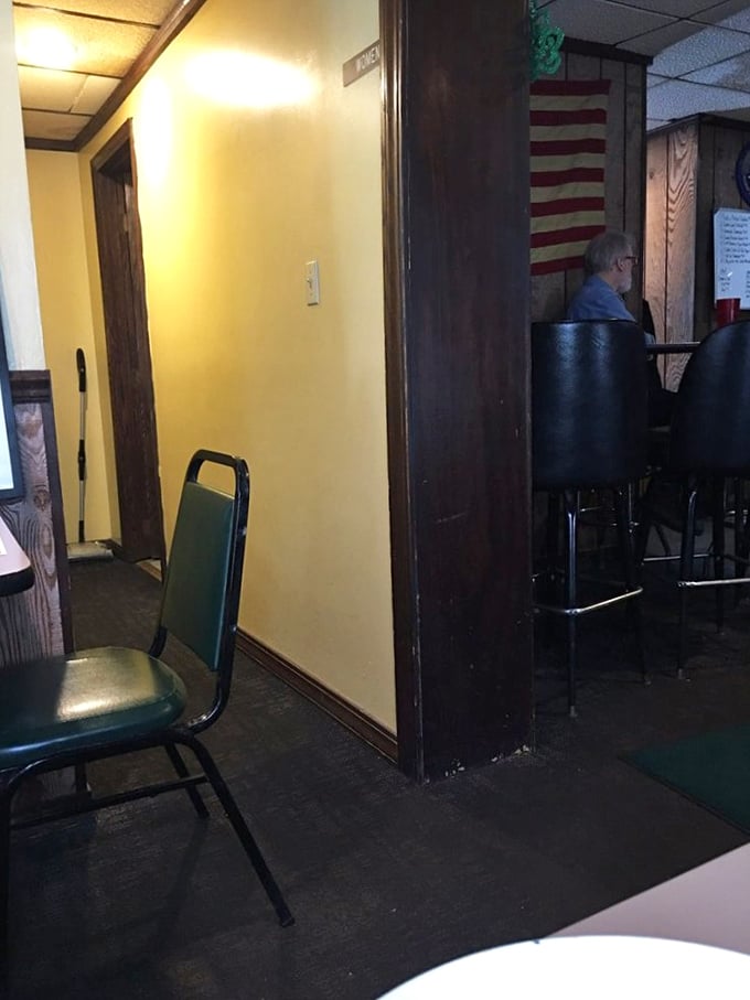 The hallway at Tim's reveals its unpretentious charm – simple furnishings and an American flag that remind you this is authentic small-town dining at its finest.