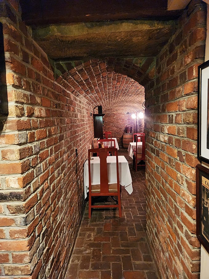 Walking down this brick corridor feels like entering a secret society where the password is "good taste." The arched ceiling whispers stories of diners past.