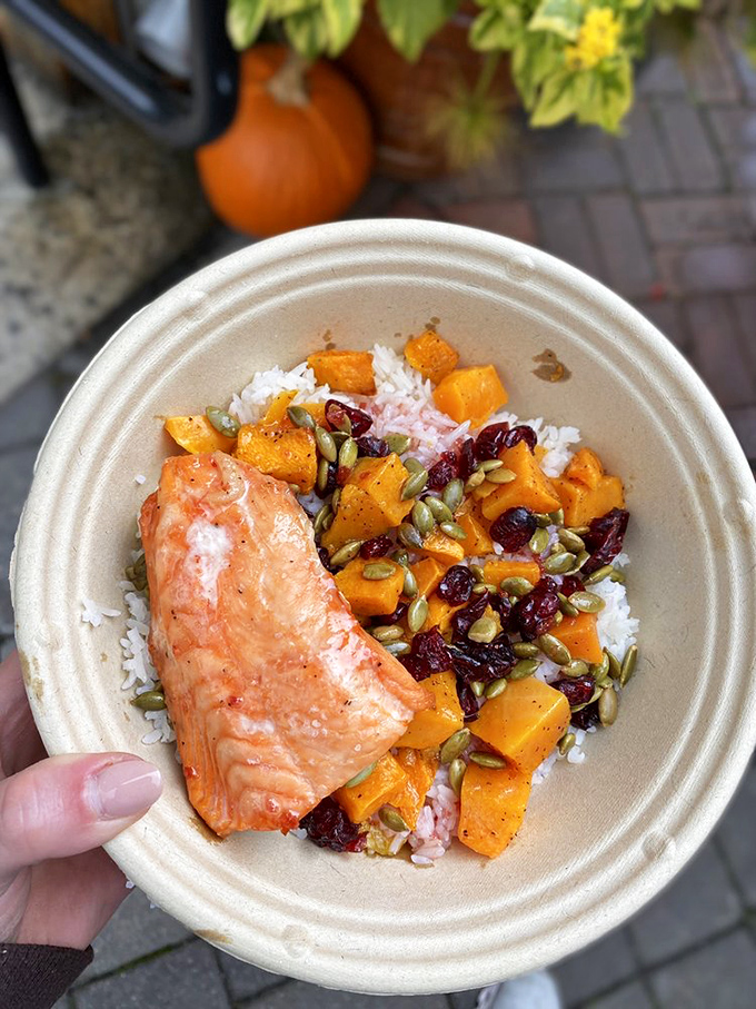 Salmon and squash bowl that makes "eating clean" feel like cheating. Those cranberries and pumpkin seeds aren't just toppings—they're little flavor bombs.