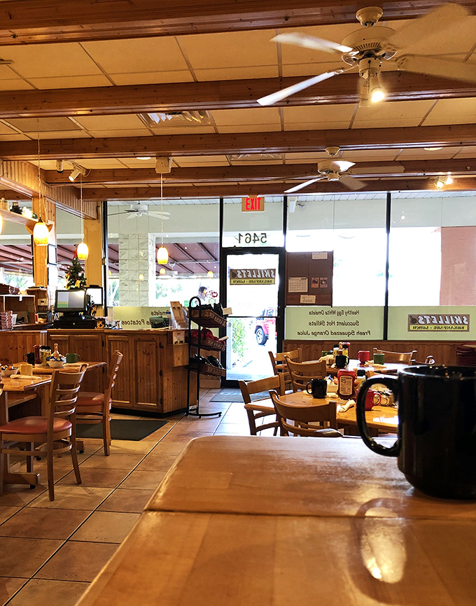 Morning light streams through windows illuminating wooden beams and tile floors – the stage is set for breakfast theater.