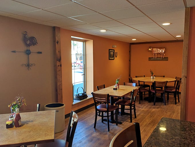 Country charm meets practical comfort in this dining area. The rooster and cow décor aren't ironic statements—they're respectful nods to the agricultural heritage that makes this food possible.