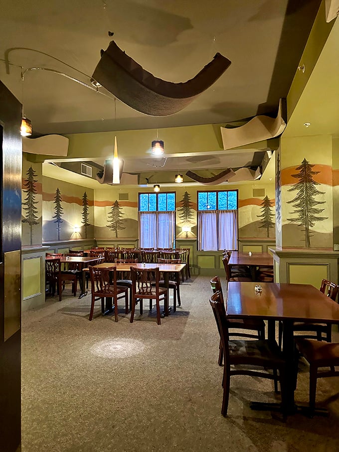 Pine tree murals and flowing fabric create an unexpected woodland escape – like dining in a stylish Pennsylvanian forest.