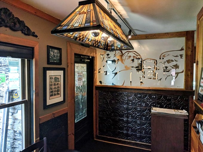 Stained glass lighting and warm wood tones create an entrance that feels like stepping into a place where everybody might know your name.