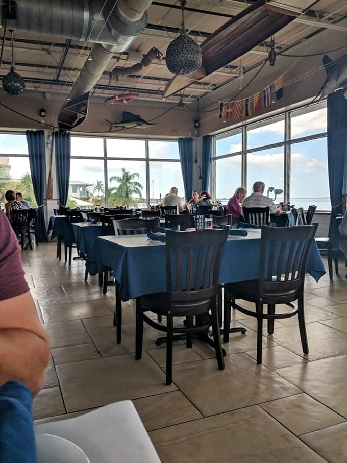 Fish mounts and nautical touches that somehow avoid the "tacky seafood joint" trap—this is maritime decor done right.