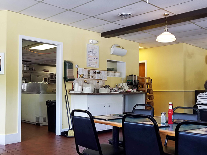 A glimpse into the kitchen's domain—where yellow walls and pendant lights create the backdrop for comfort food magic.