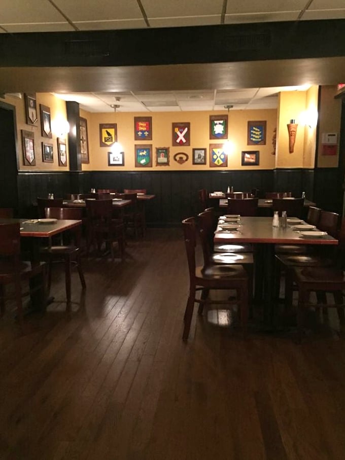 The warm interior showcases colorful heraldic shields, creating an atmosphere that's part pub, part family gathering place.
