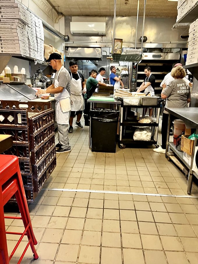 The kitchen ballet in full swing. These sandwich artists move with purpose, creating edible masterpieces while hungry eyes watch their every move.