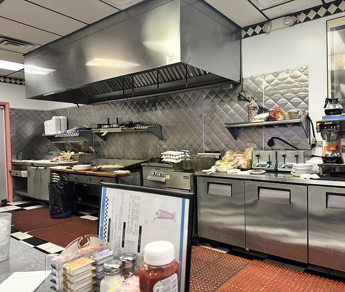 The kitchen—where breakfast dreams are born on a well-seasoned flat top that's seen more action than an action movie.