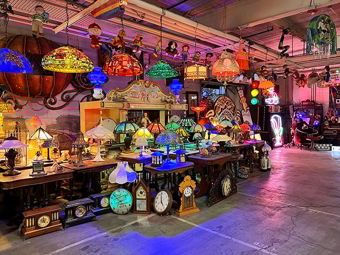 The lamp section glows with Tiffany-inspired magic. Each shade tells a different story, casting colorful shadows on nearby antique clocks.