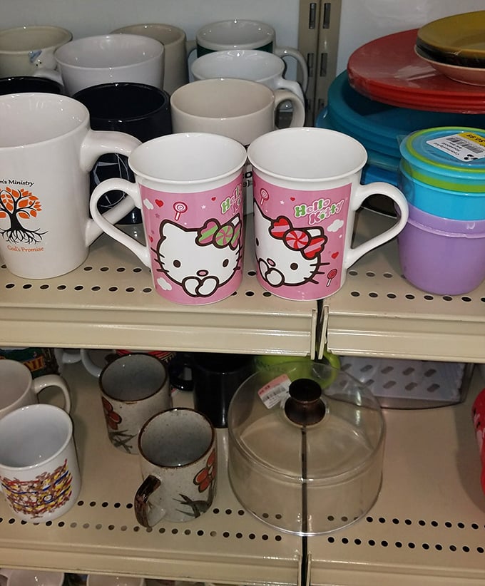 Hello Kitty mugs nestled among everyday drinkware—proof that morning coffee tastes just as good when sipped from someone else's discarded joy.