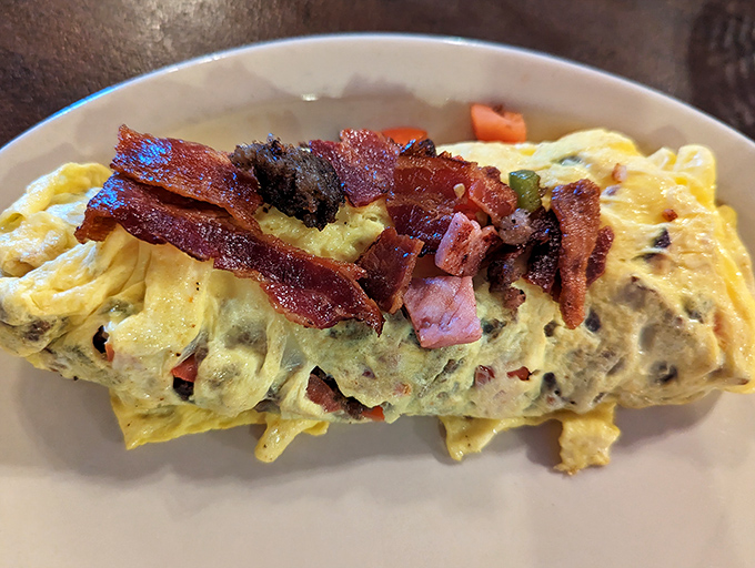 An omelet that's clearly been to the gym – bulging with fillings and topped with bacon that's achieved that perfect crispy-but-not-burnt state of excellence.