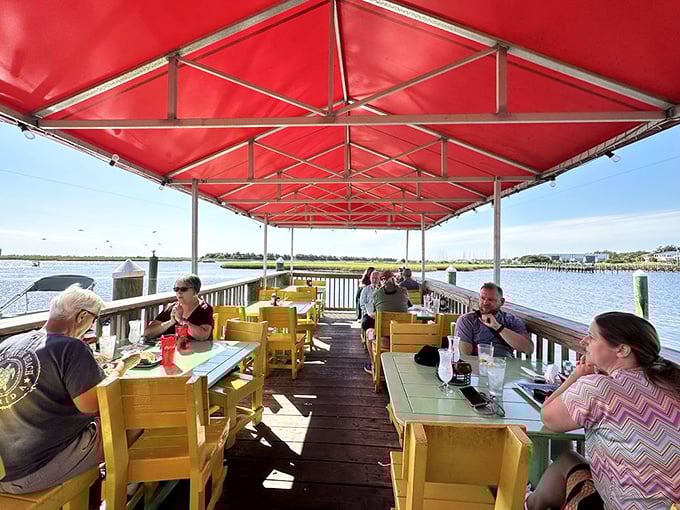 Yellow chairs, turquoise tables, and endless water views—this outdoor seating area is practically begging you to order another round and stay awhile.