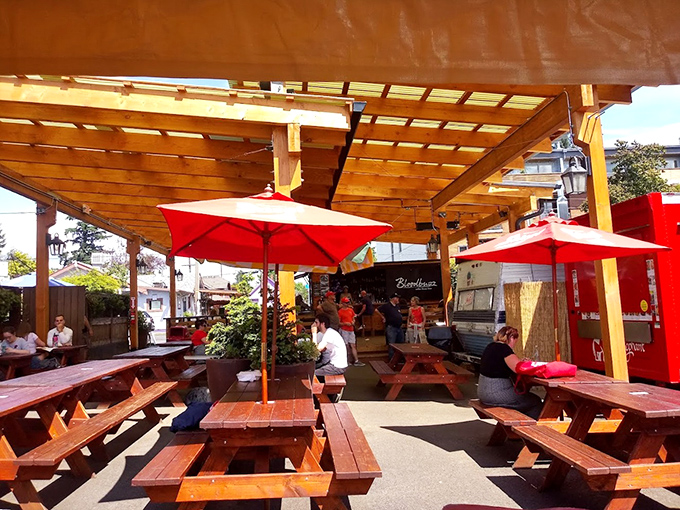 The outdoor seating area—where time slows down and the only urgency is beating the guy eyeing your last bite of brisket.