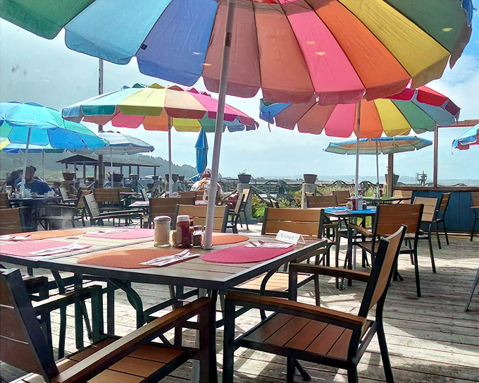 Outdoor dining under rainbow umbrellas – because sometimes great seafood tastes even better with a side of vitamin D and ocean breeze.